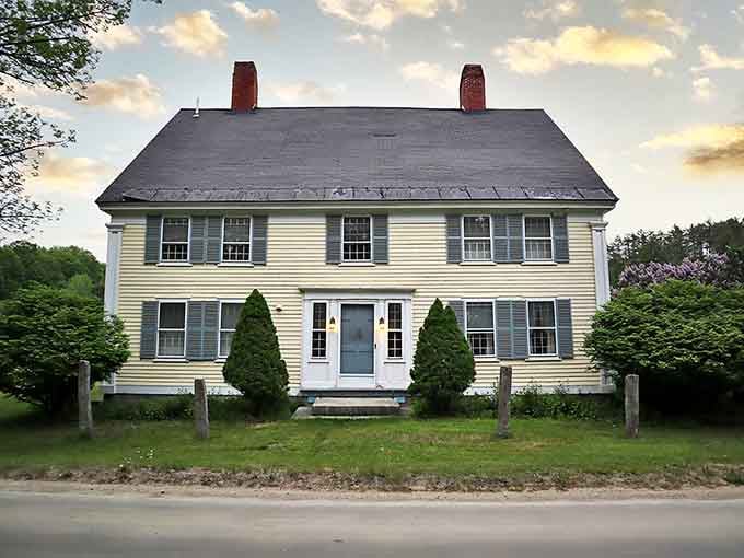 This stately yellow colonial home with perfect symmetry and twin chimneys is the architectural equivalent of finding matching antique candlesticks.