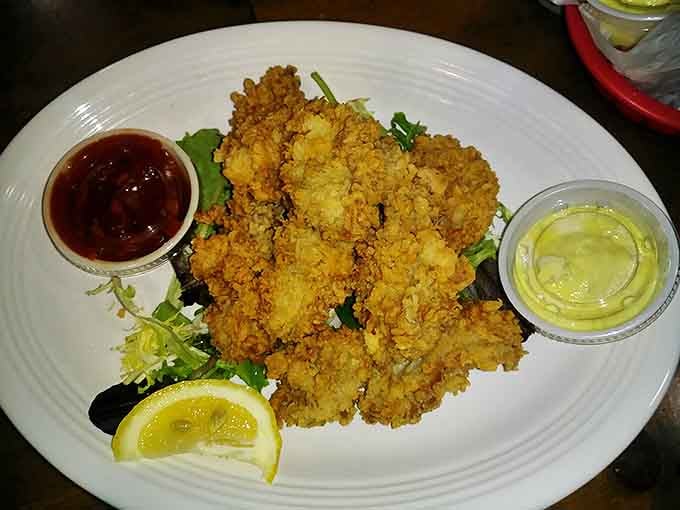 Fried oysters that maintain their briny soul beneath a crispy cornmeal crust&mdash;a textural masterpiece served with dipping sauces for good measure.