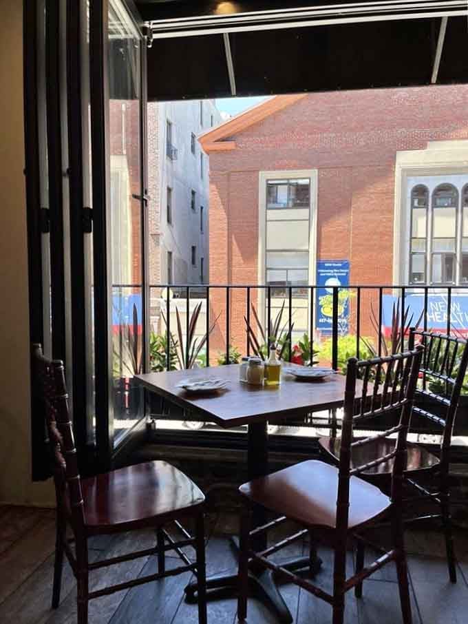 Dining with a view of Hanover Street through open windows. Fresh air, great food, perfect people-watching. North End perfection.