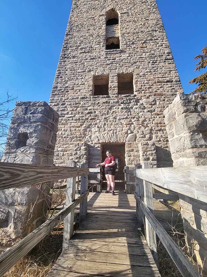 Visitors explore the tower ruins, living out their best medieval fantasy without the uncomfortable armor.
