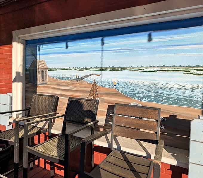 That waterfront mural and cozy seating create the perfect spot to relax before or after your seafood feast arrives.