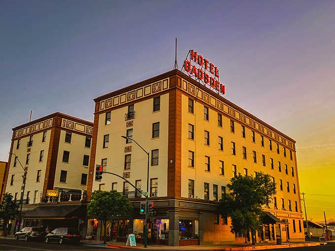 Hotel Gadsden glows majestically at sunset, its neon sign a beacon of hospitality against the desert twilight.