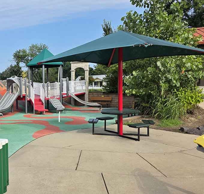 Green canopies providing blessed relief from Missouri sun that could otherwise fry eggs on those slides.