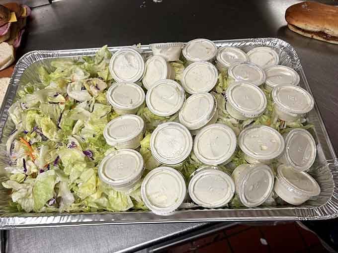 A salad tray with enough individual dressing cups to make you feel like you're catering a wedding, not just feeding your table.