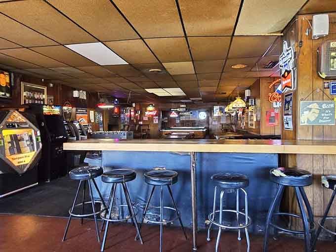 Classic bar stools lined up like soldiers, ready to support weary souls seeking cold beer and good conversation.