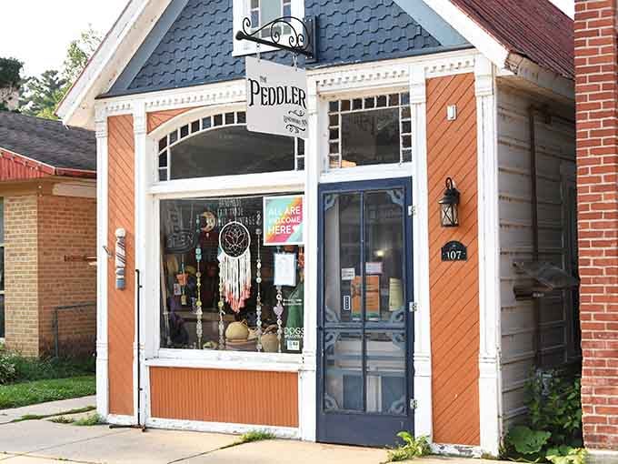 The Peddler's orange facade pops like a sunset against the streetscape, proving small shops can have big personality.