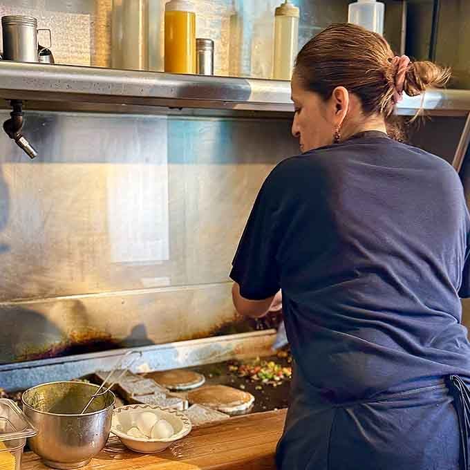 Behind the scenes, skilled hands work the griddle, transforming simple ingredients into the comfort food of your dreams.