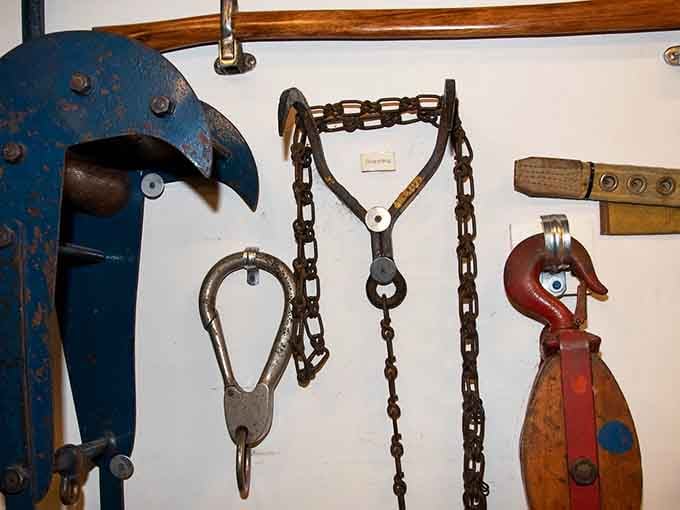 Heavy chains and hooks hang like industrial jewelry, each tool designed for specific rescue scenarios and emergencies.