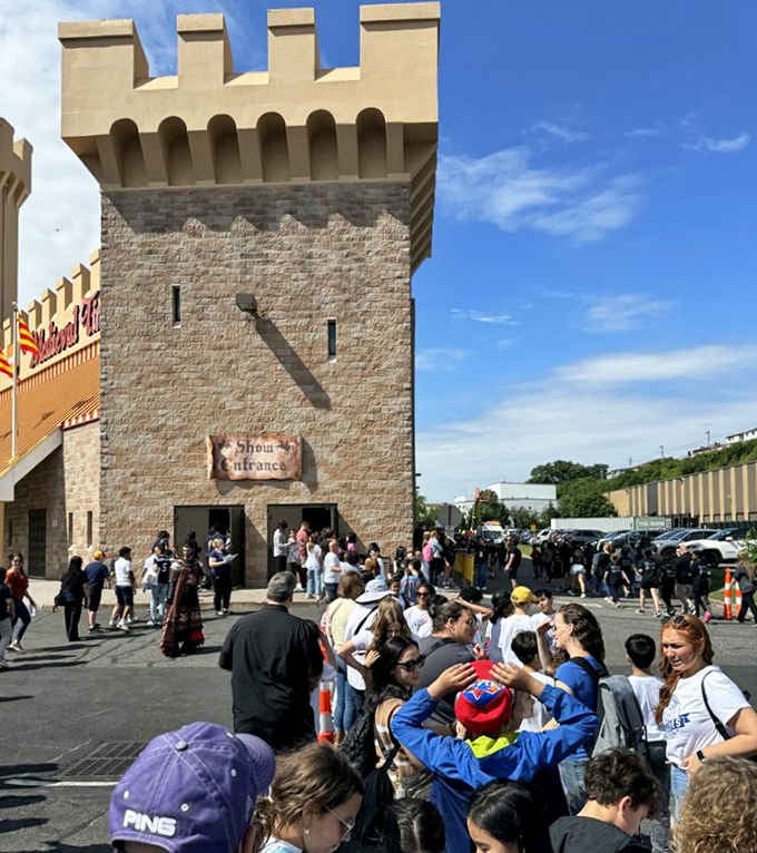 Crowds gather outside the castle entrance, ready to trade their smartphones for goblets and good times.