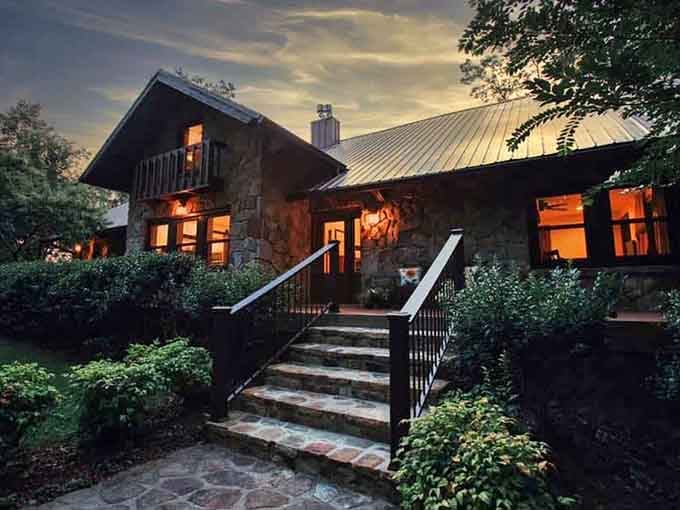 This stone cottage glows at dusk like something from a storybook that forgot to mention Alabama.