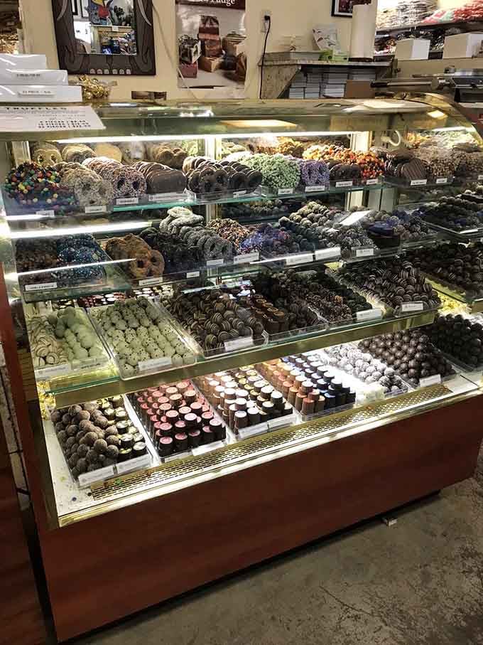 Handcrafted chocolates fill the display case, offering gourmet options alongside the nostalgic penny candies and bulk sweets.