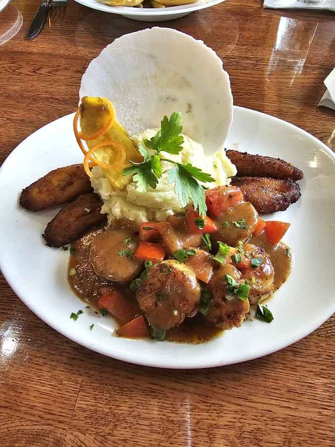 Scallops nestled with plantains and rice, creating a harmony of flavors that would make any food lover weep.