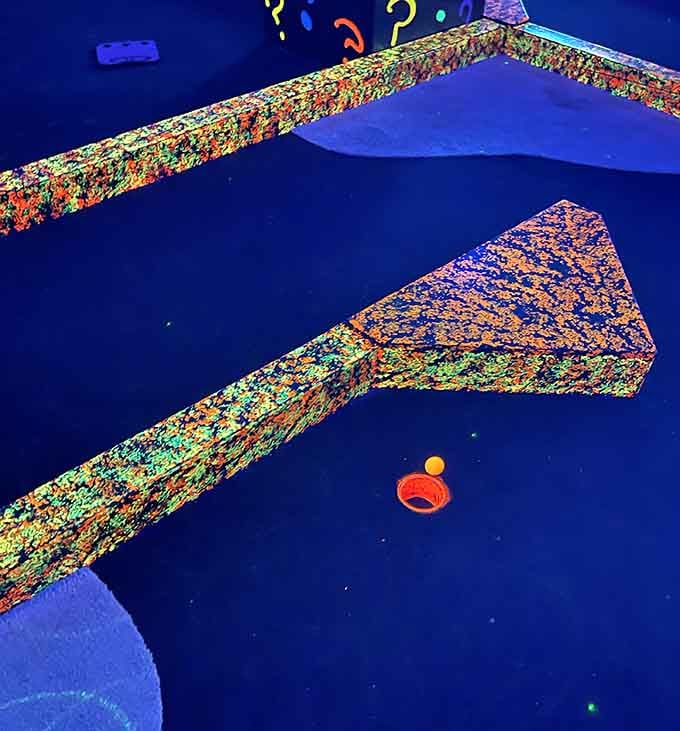 That glowing orange ball is about to teach you that physics works differently under blacklight conditions.