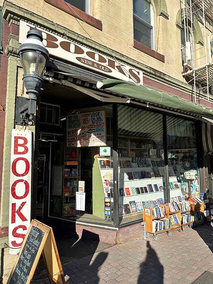 The corner entrance welcomes you with displays that spill onto the sidewalk, because containing this many books indoors is physically impossible.