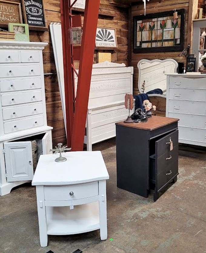 Refinished furniture sits alongside pieces waiting for their makeover, each one a blank canvas for creativity.