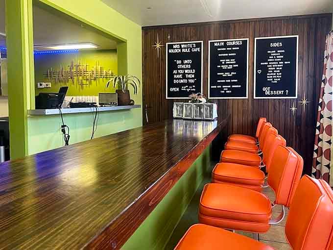 Retro orange chairs and a menu board that promises soul food excellence, delivering on every single word.