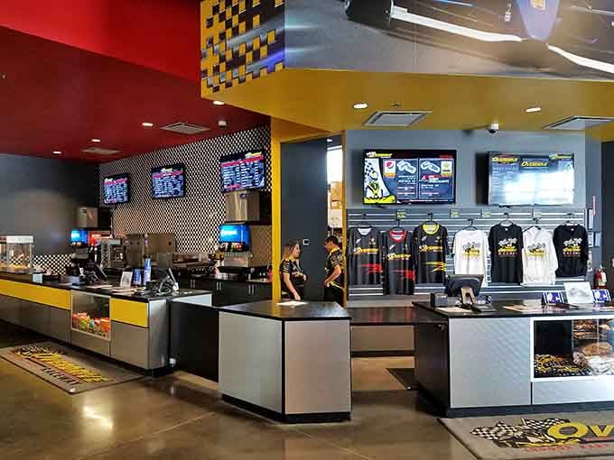 The sleek check-in counter uses racing colors and modern design, making even paperwork feel slightly more exciting.