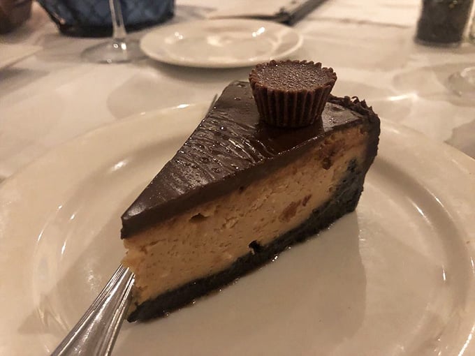 A slice of peanut butter cheesecake that makes sharing seem like a terrible idea you'll immediately regret agreeing to.