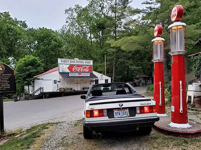 Vintage gas pumps standing guard like red sentinels from an era when filling up meant friendly conversation.