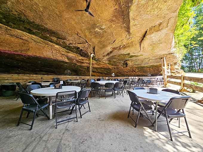 Outdoor seating under the massive bluff where the rock overhead makes you feel wonderfully small and incredibly hungry.
