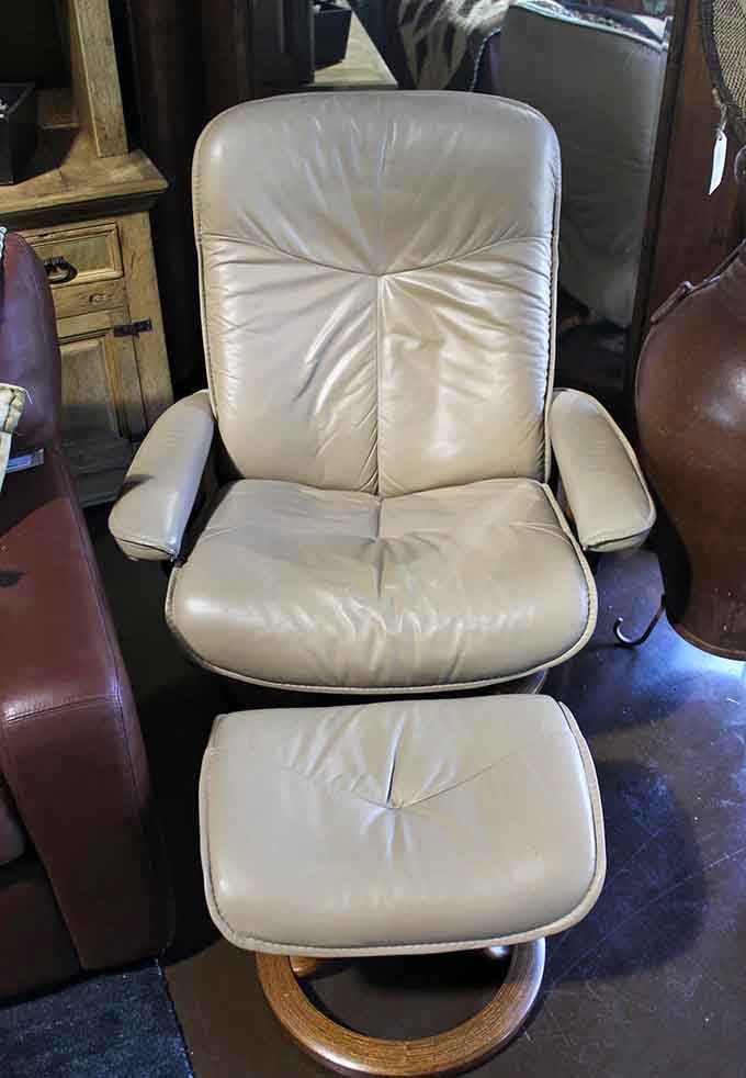 This cream leather recliner silently promises to be the spot where you'll finally finish that novel you've been meaning to read.