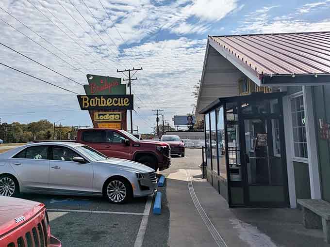 The exterior view showing that iconic signage standing tall, guiding hungry travelers to their smoky pork destination for decades.