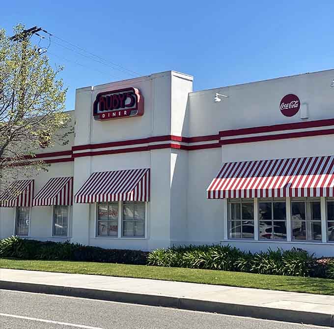 The pristine white exterior with red striping looks exactly like your grandparents' favorite weekend breakfast spot.