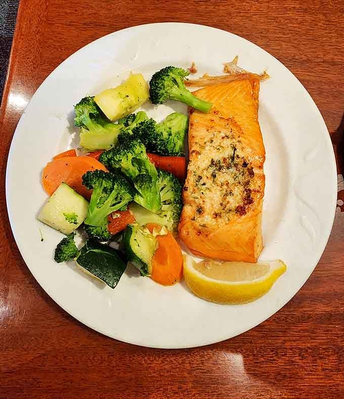 Salmon that's perfectly cooked with vegetables that actually taste like vegetables. A plate that proves "healthy option" and "delicious" aren't mutually exclusive terms.