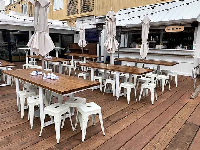 The outdoor deck with communal tables and umbrellas is where you want to be on sunny days, soaking up rays and seafood.