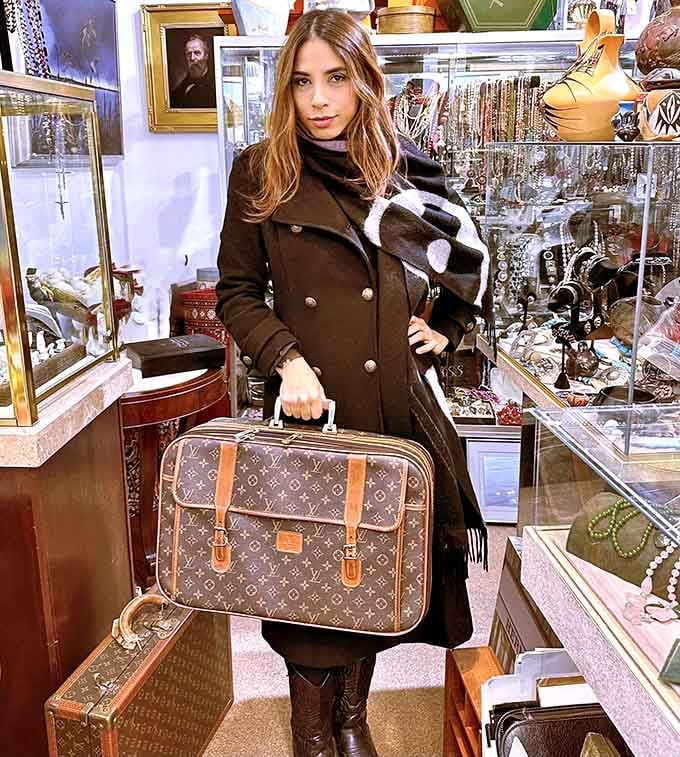 The thrill of the find captured in one image. That vintage Louis Vuitton suitcase has probably seen more interesting journeys than most modern travelers.
