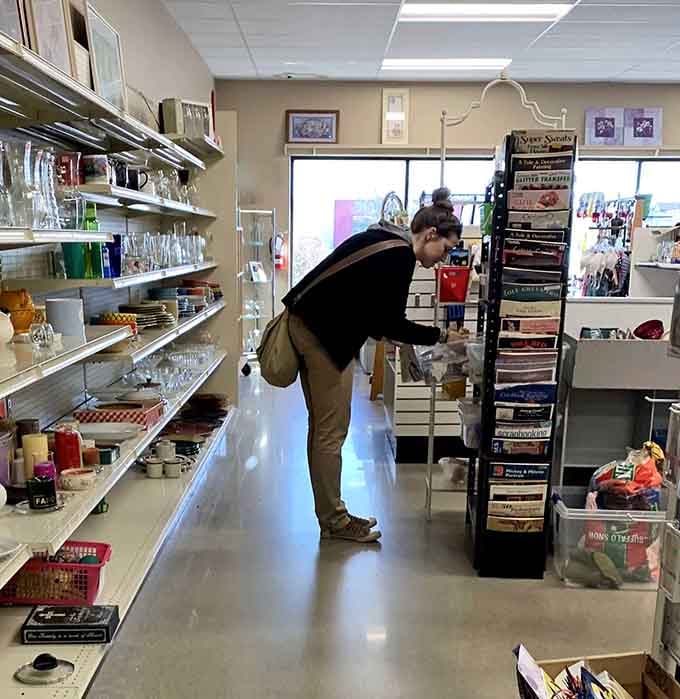 Treasure hunters in their natural habitat, carefully examining potential finds. The thrill of discovery is written all over this shopper's focused posture.