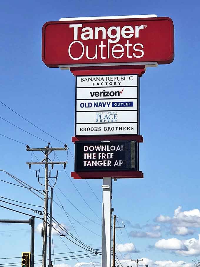 The iconic red Tanger sign stands tall, a beacon of hope for wallets everywhere and a promise of retail adventures ahead.