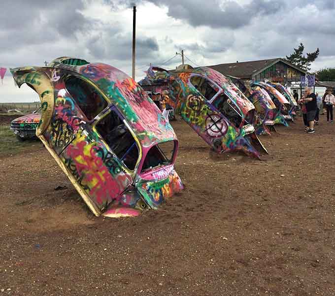 These tilted Beetles look like they're doing synchronized swimming, except they're buried in dirt and covered in spray paint.
