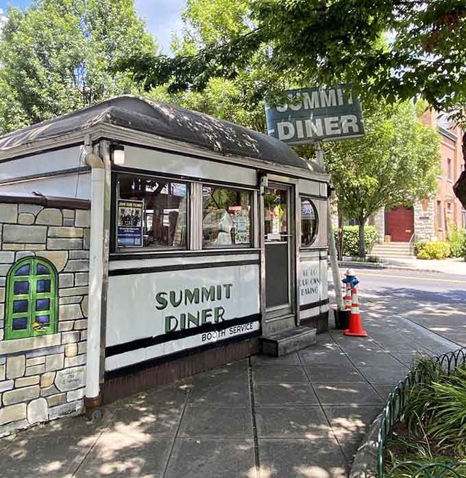 The classic diner sign stands proud, beckoning hungry travelers like a lighthouse guides ships to safe harbor.