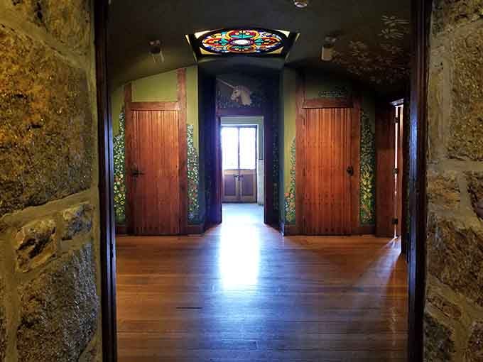 Stained glass and polished wood floors create hallways where every step feels like entering another era.