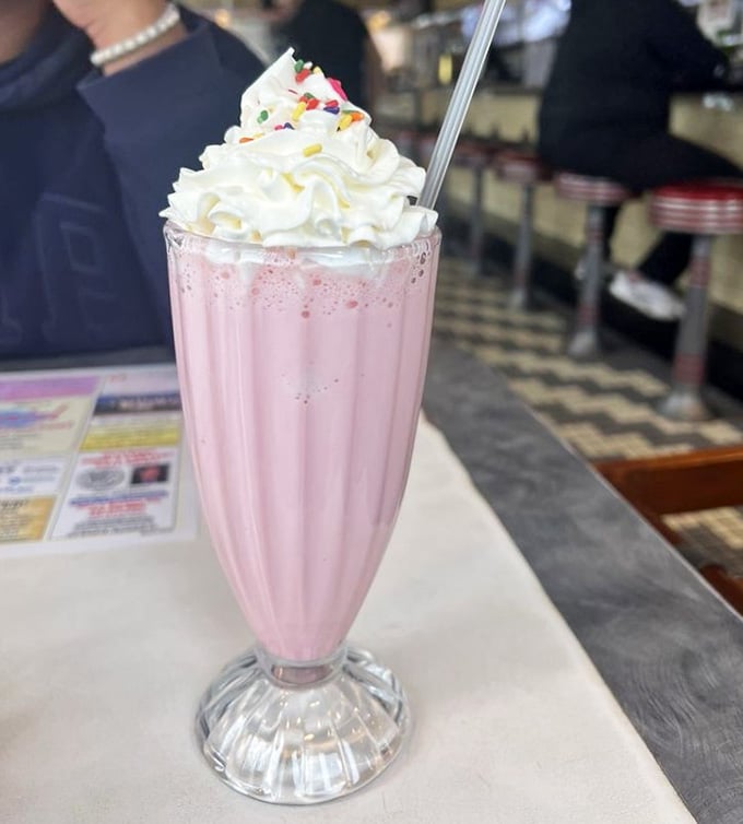 That strawberry milkshake towers high with whipped cream, demanding respect and a very sturdy straw.