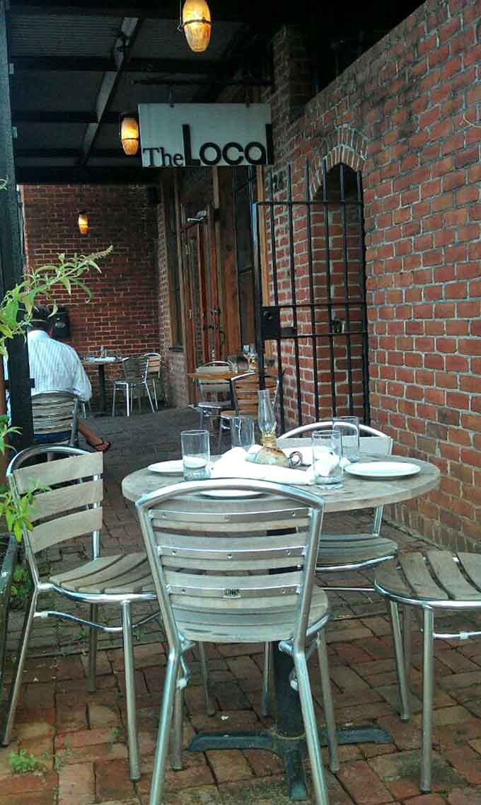 Outdoor seating on brick pavers under the evening sky turns a regular meal into a memorable dining experience.