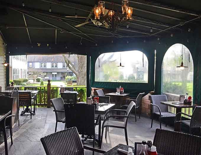 Covered patio seating with arched openings frames the outside world like a series of peaceful landscape paintings.