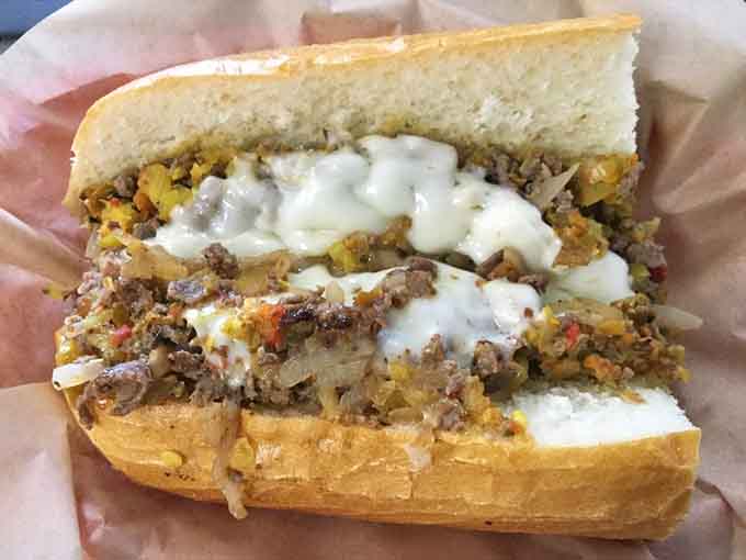 That Philly cheesesteak cross-section reveals the perfect ratio of meat, cheese, peppers, and onions that makes grown adults weep with joy.