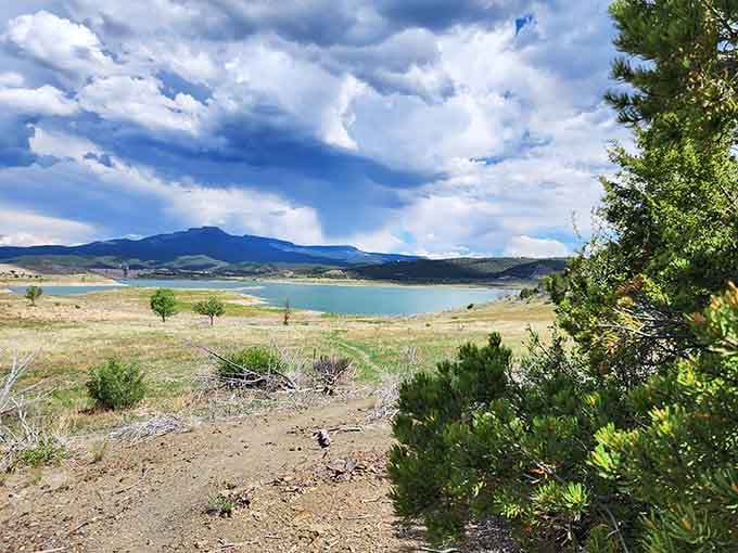 Trinidad Lake stretches beneath dramatic skies, offering fishing and recreation without the crowds or the attitude of busier destinations.
