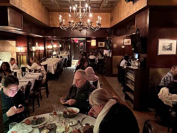 Diners gather beneath chandeliers in this historic space, sharing meals where millions once sat locked behind steel walls.