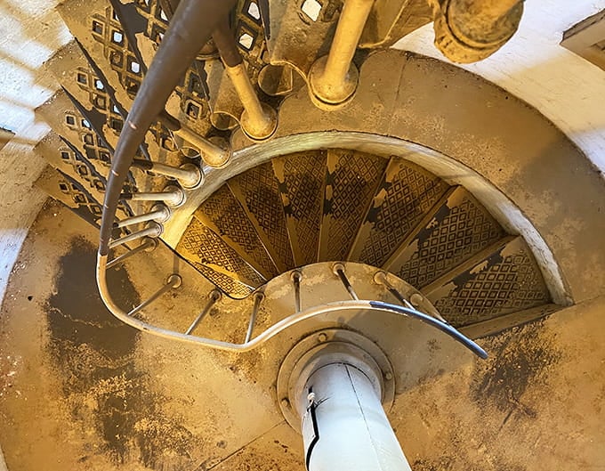 That spiral staircase winds upward like a nautical DNA helix, promising spectacular rewards at the top.
