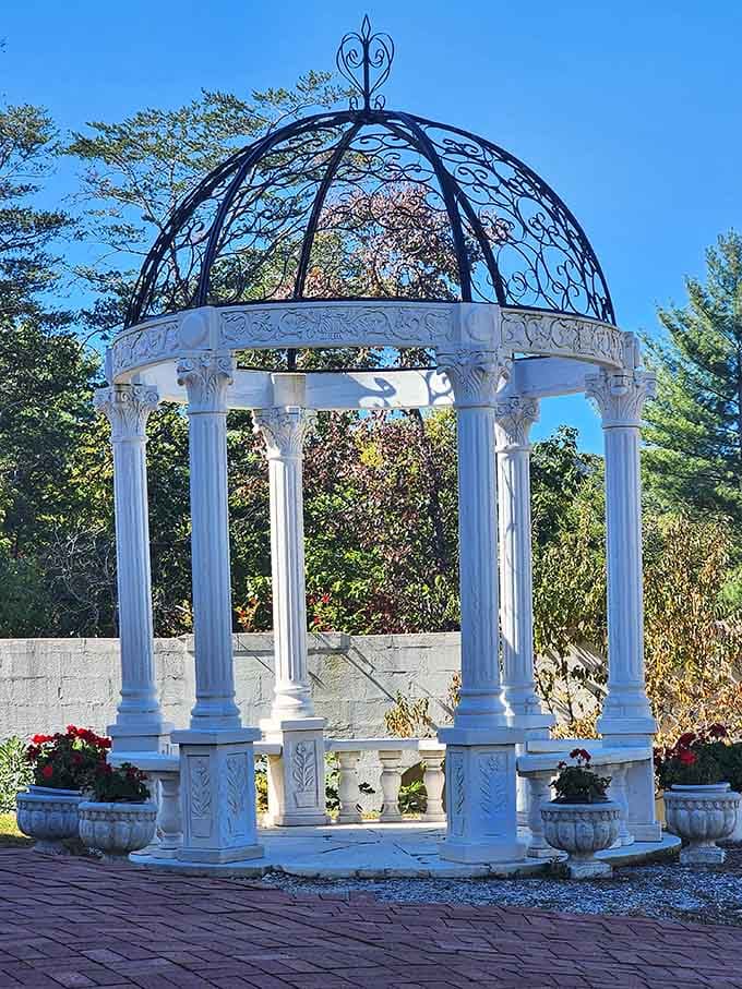 White gazebo with ornate ironwork dome creates picture-perfect wedding spot that cameras absolutely love capturing forever.