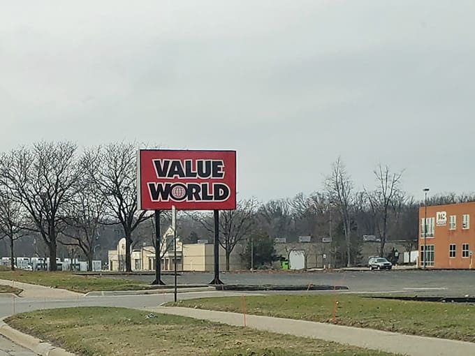 The roadside sign guides shoppers home, a beacon for those who appreciate value over vanity pricing.
