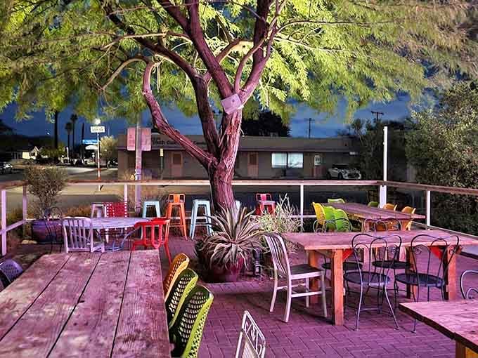The outdoor patio glows pink at night, turning a simple meal into a magical desert experience.
