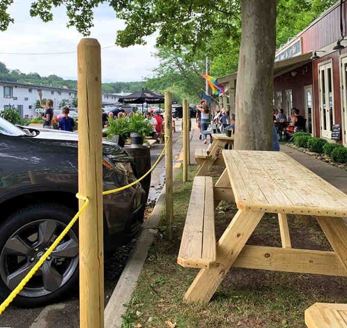 Fresh picnic tables lined up along the sidewalk invite you to dine alfresco and soak up summer vibes.