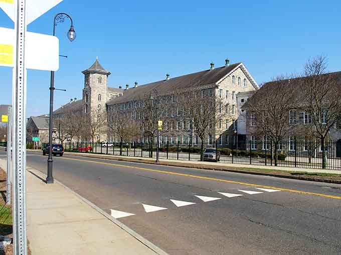 Historic mill buildings line the streets, their brick facades holding stories of workers, industry, and a town that refuses to forget.