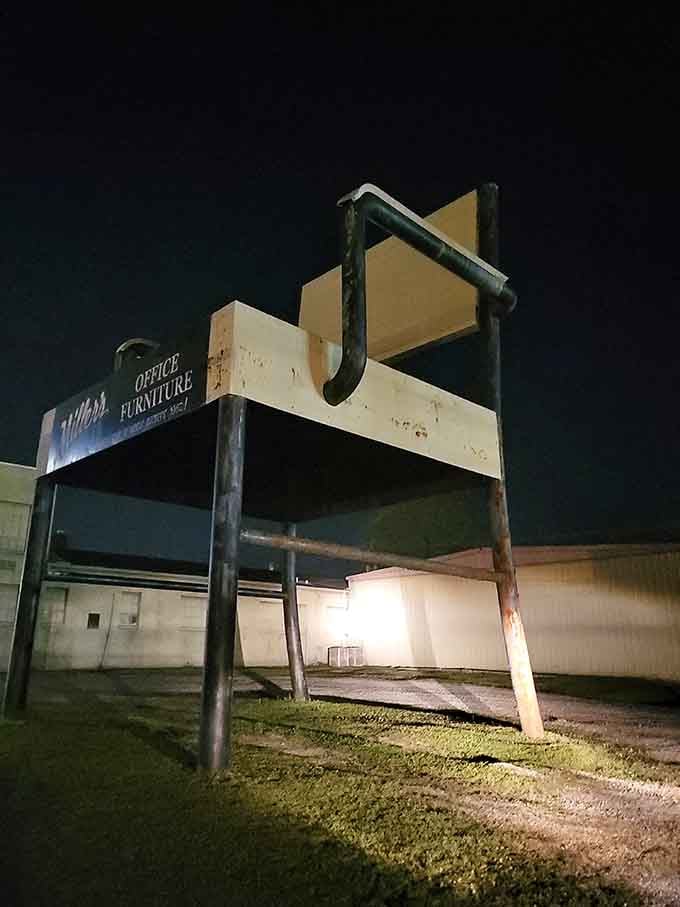 Even at night, this illuminated giant reminds passing drivers that office furniture can be genuinely entertaining.