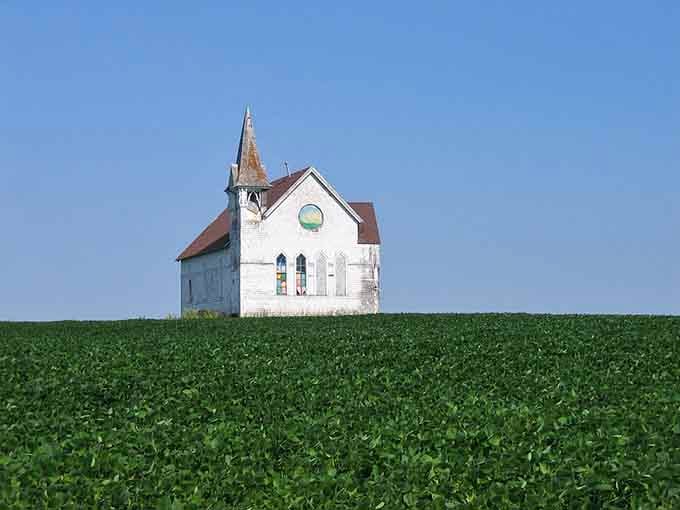 A solitary country church rises from emerald fields like something from an Andrew Wyeth painting&mdash;serene, timeless, and quintessentially American.
