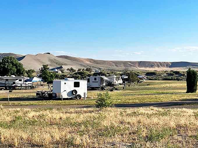Home sweet temporary home! RVs and campers nestle at the foot of towering dunes, creating a neighborhood with the best views in Idaho.
